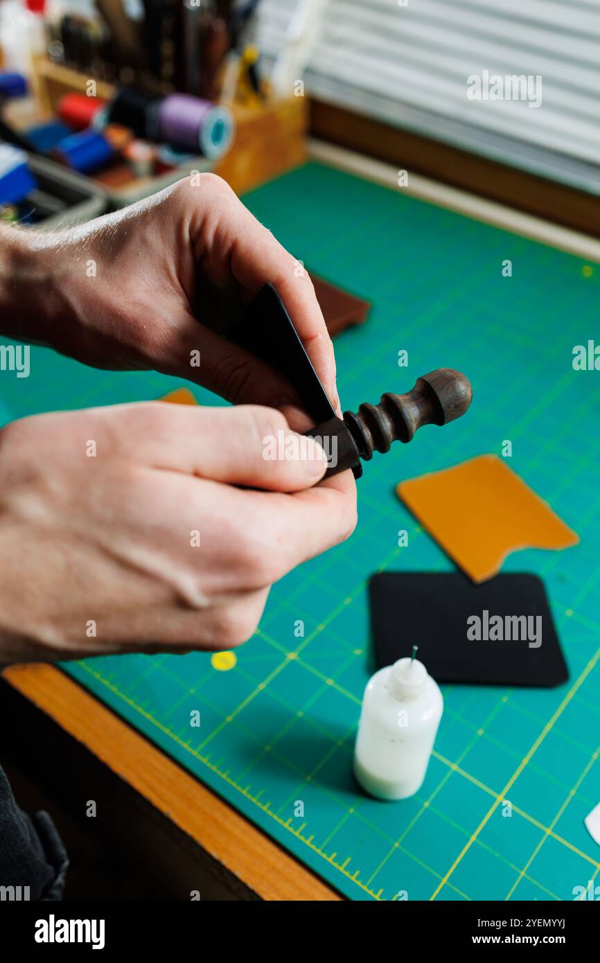 The hands of the master sew handmade leather products. Men's hands ...