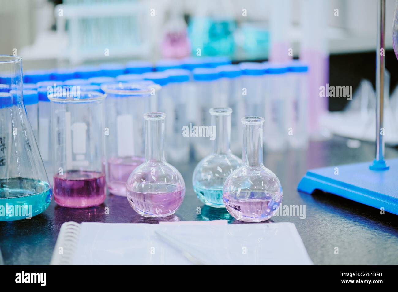 Lab equipment displaying several glass containers filled with different ...