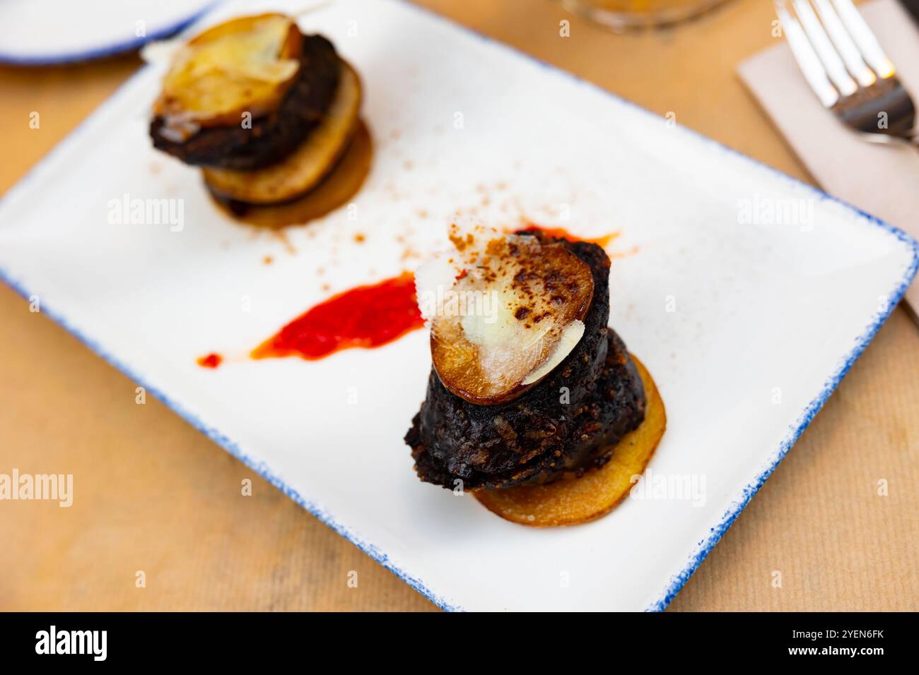Timbale with fried morcilla, caramelized pear and cheese Stock Photo ...