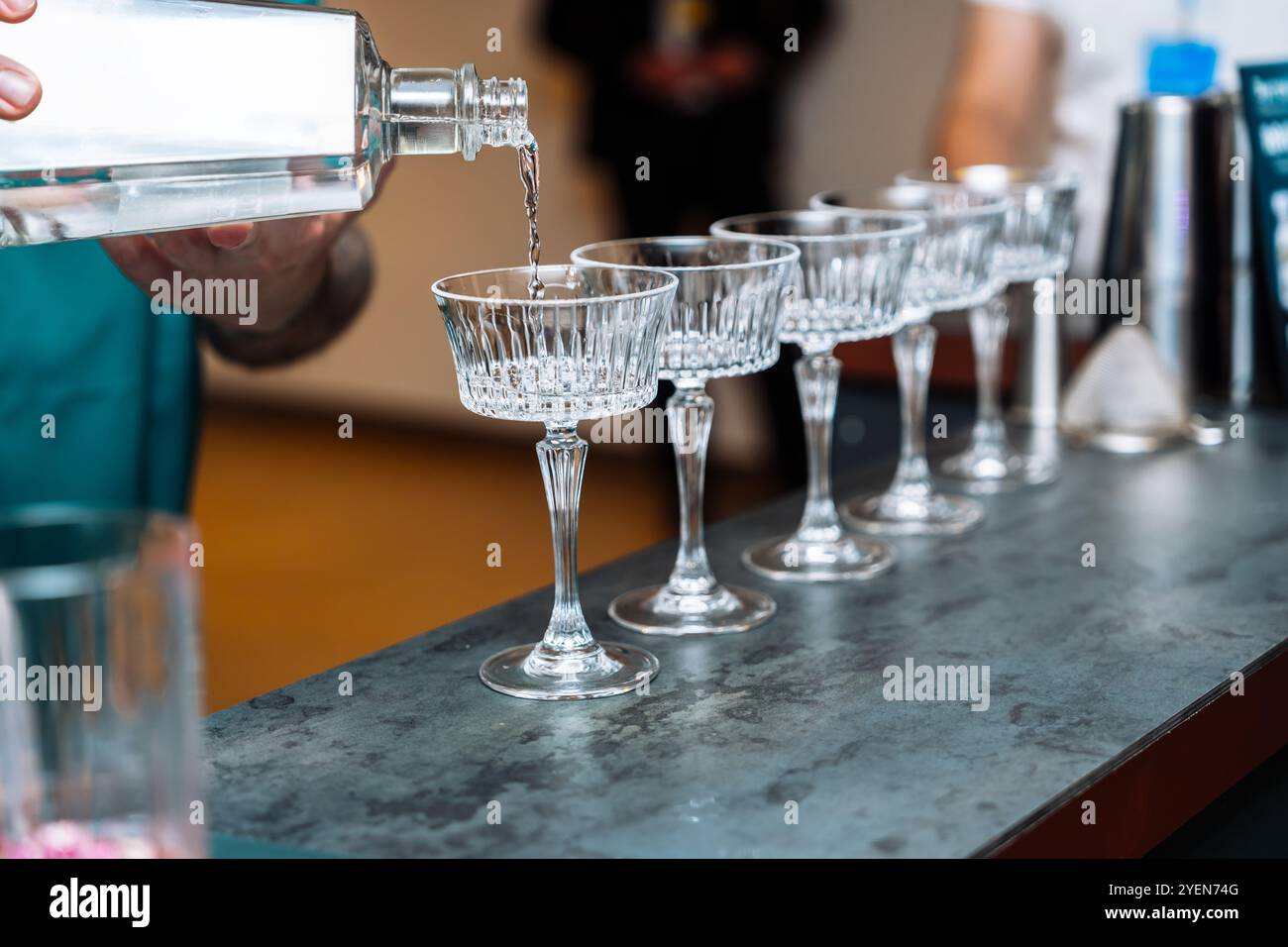 Pouring spirits for an alcohol tasting event with elegant glassware ...