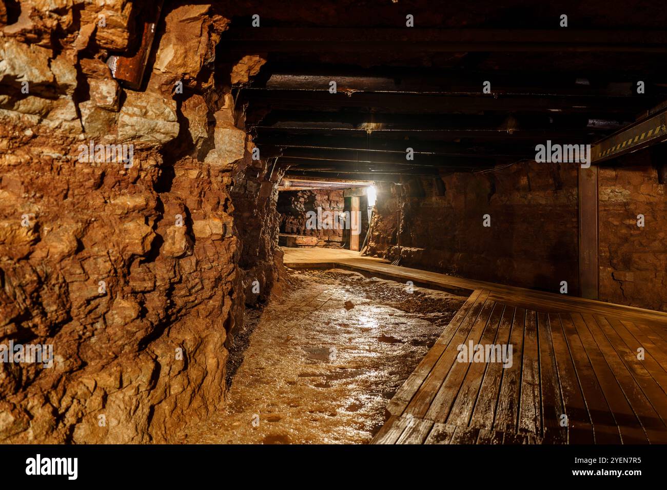 Exploring the Long Dark Wet Mine Tunnel with Wooden Walkway and Rough ...