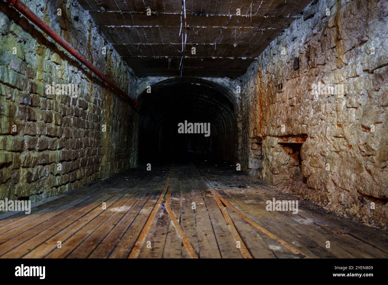 Old creepy dark scary underground tunnel with brick walls and wooden ...