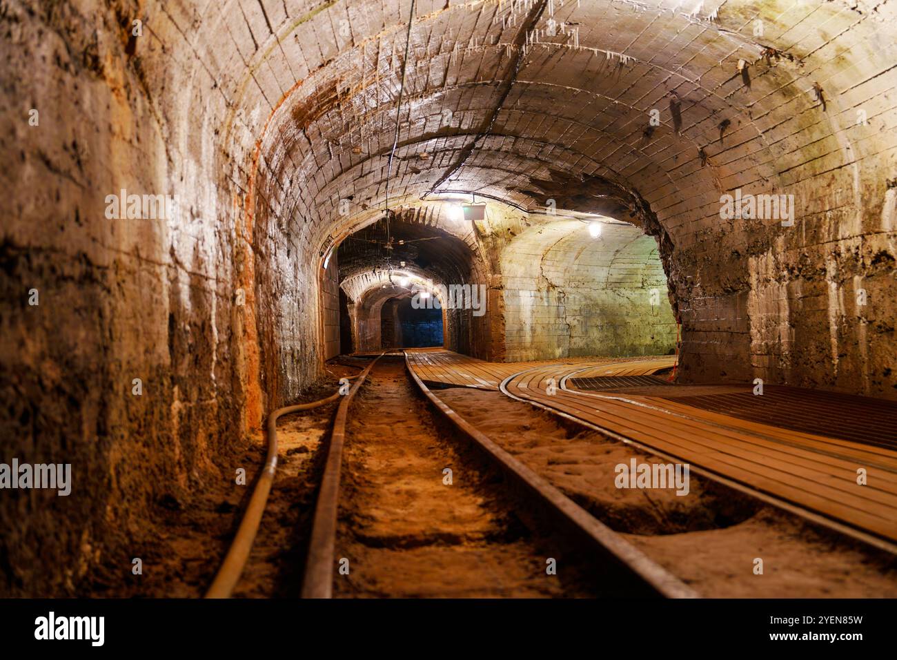 Exploring an Old Dark Mine Tunnel with Rusty Railroad Tracks Leading ...