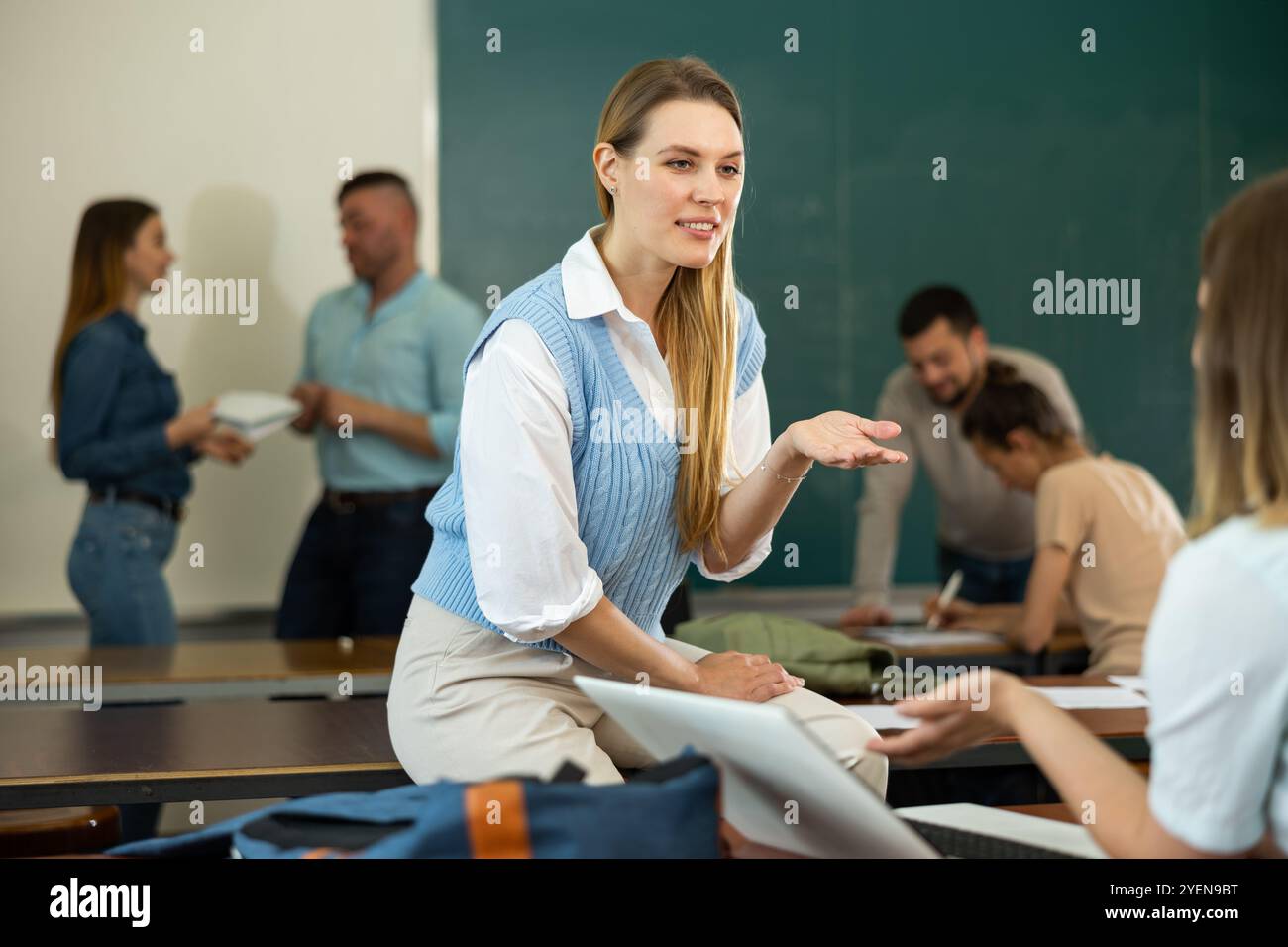 Group of students talking in classroom having break between lessons ...