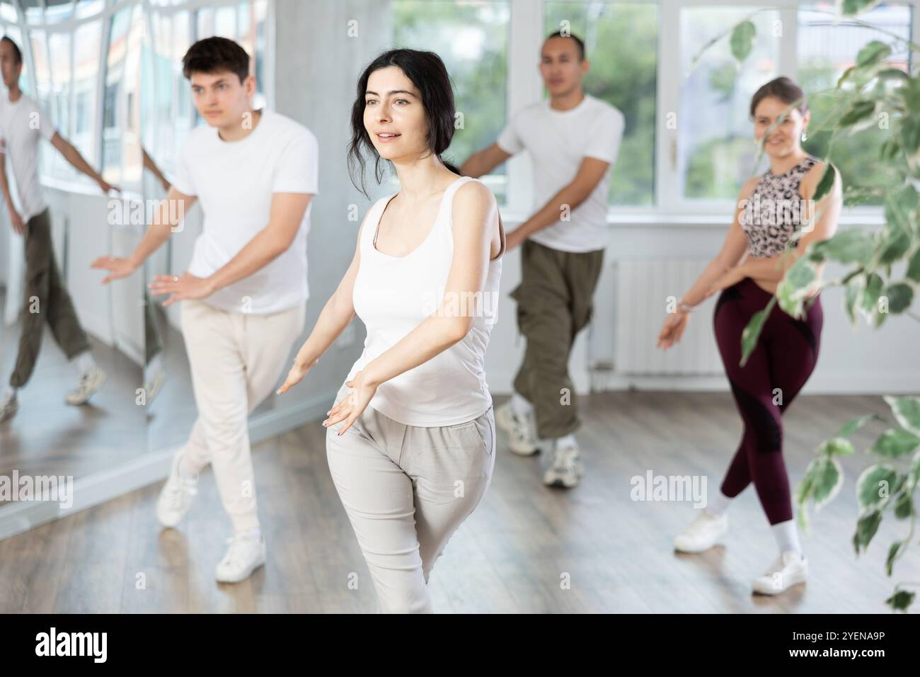 Girl enjoys active dancing, learns new movements, moves synchronously ...