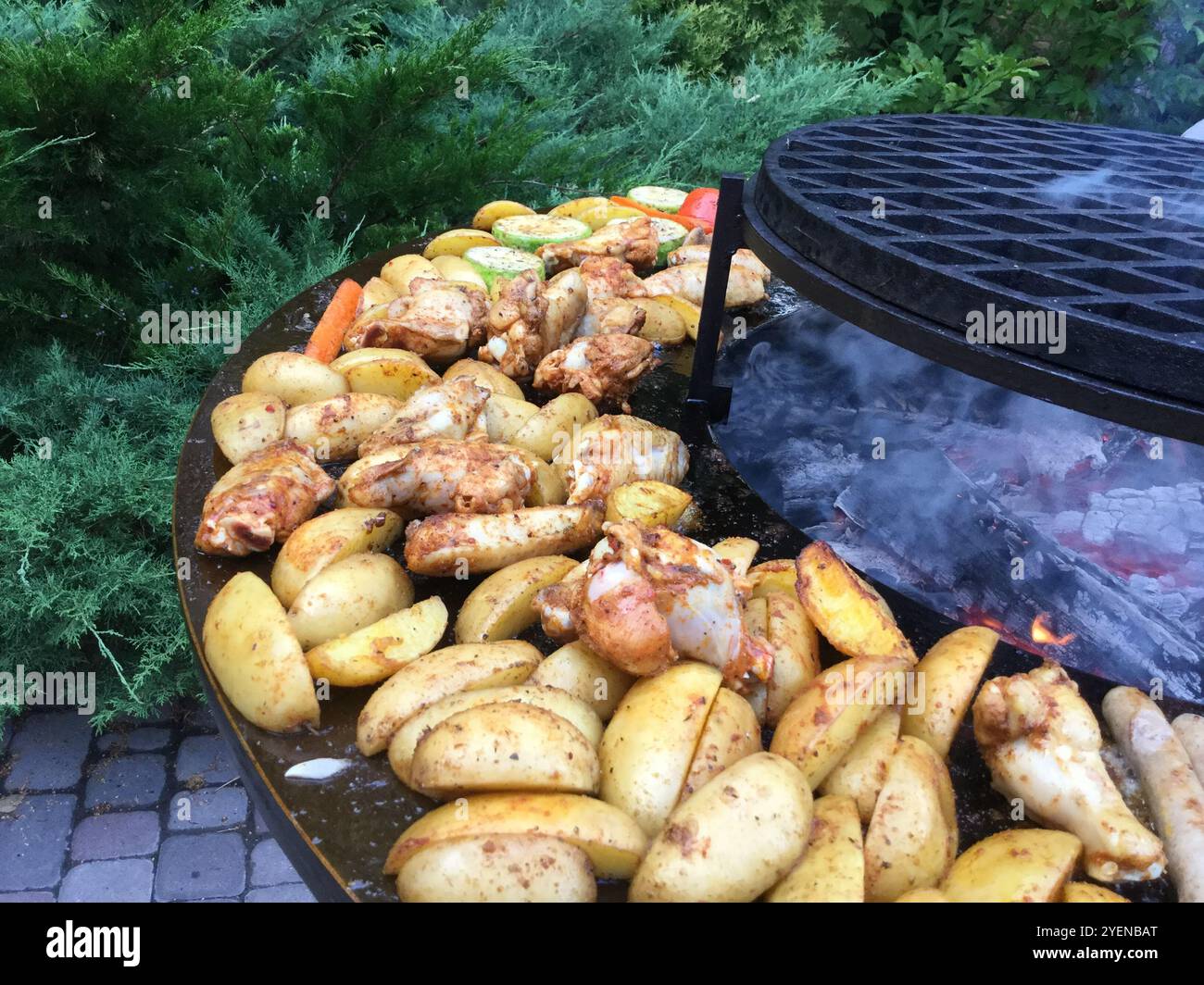 Outdoor Barbecue with Grilled Chicken and Potatoes Stock Photo - Alamy