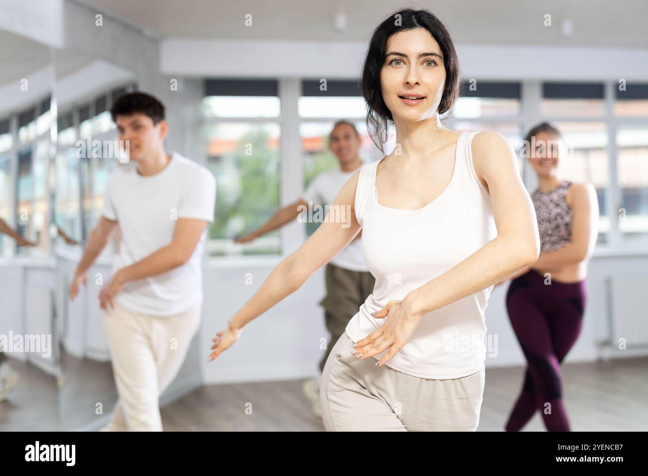 Girl enjoys active dancing, learns new movements, moves synchronously ...