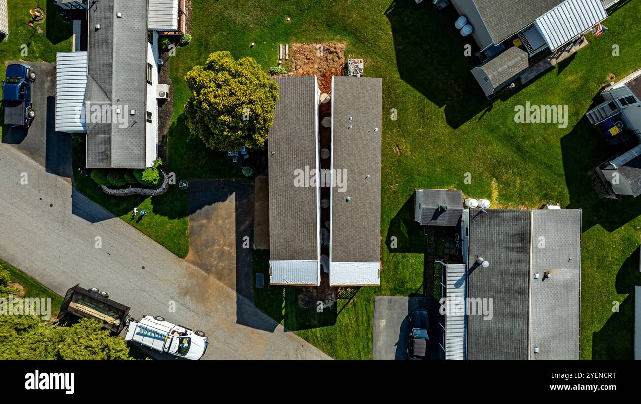 Aerial view shows mobile, manufactured homes lined along a tranquil ...