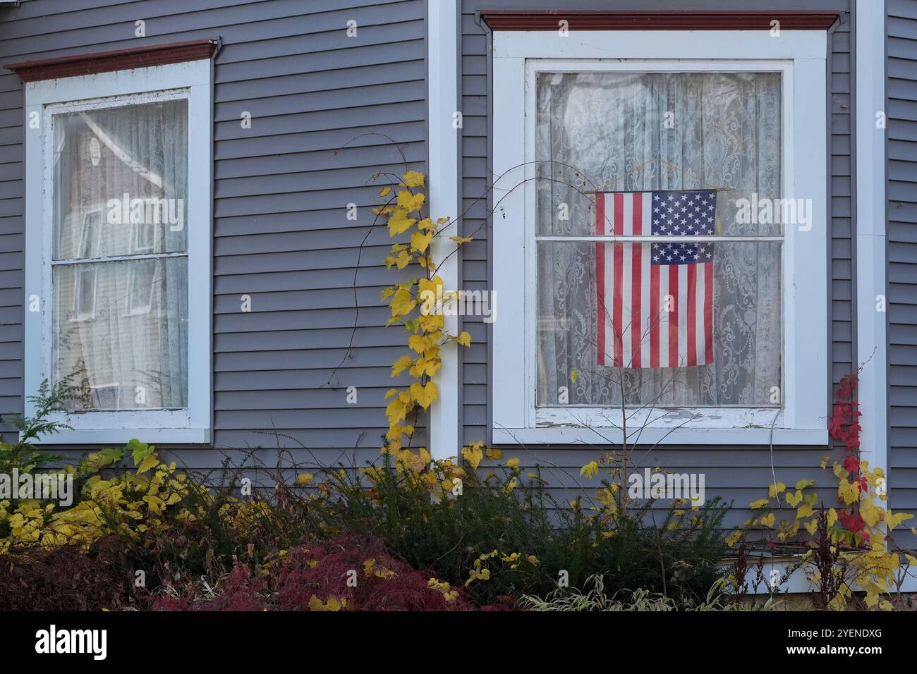 An American flag is displayed in the window of a Janesville, Wis., home ...