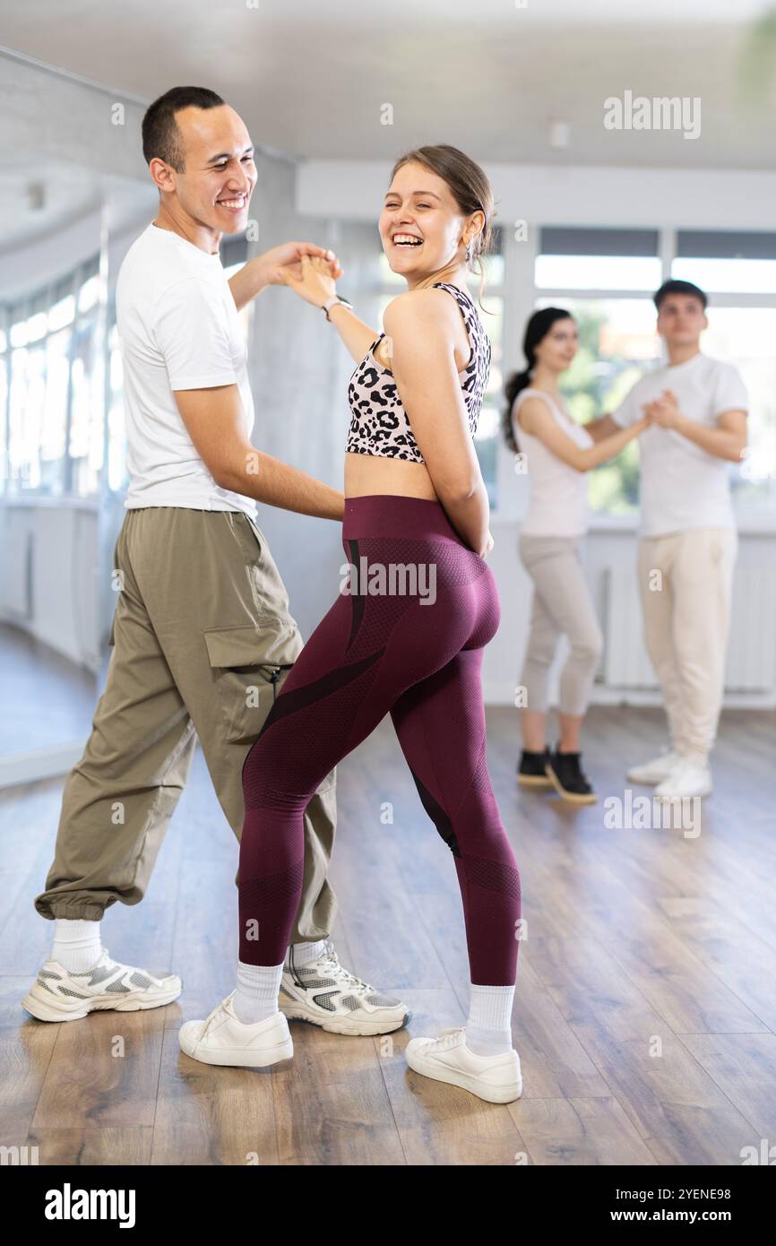 Girl paired up with young man, they train to perform disco fox dance ...