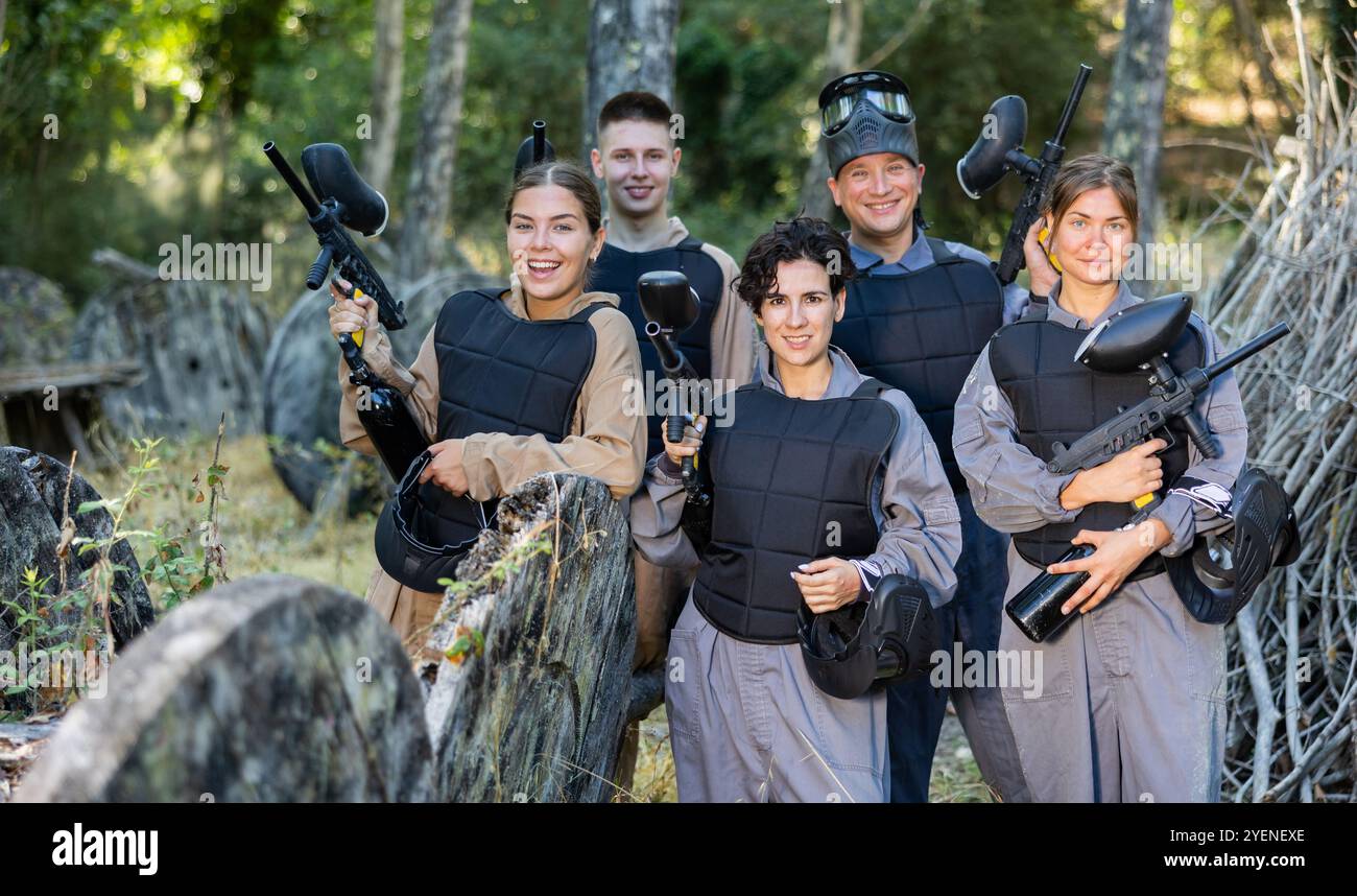 Group photo of cheerful male and female paintball players Stock Photo ...