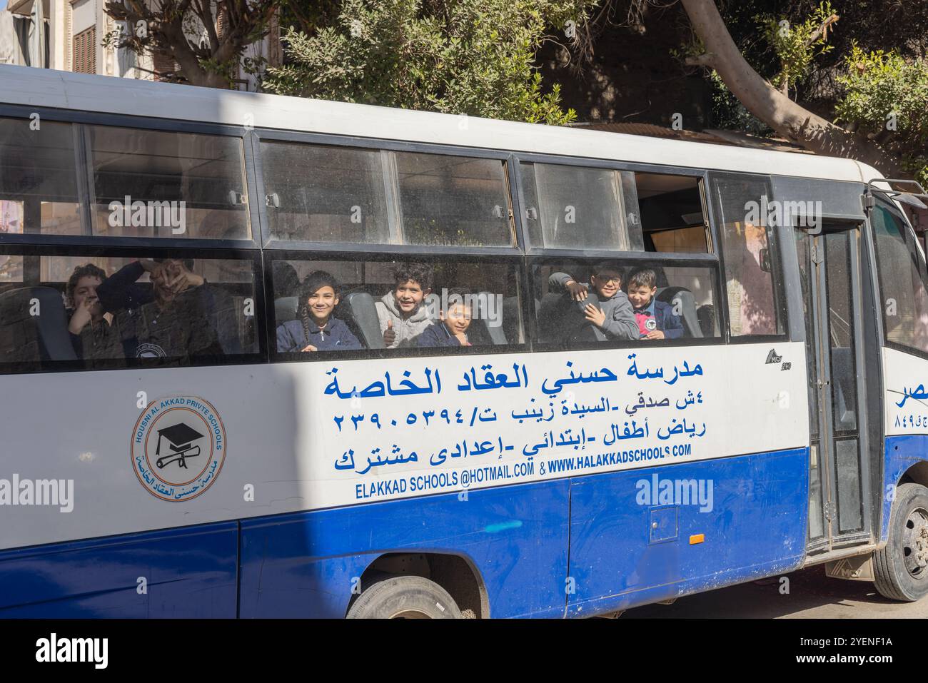 Al-Darb Al-Ahmar, Old Cairo, Cairo, Egypt. February 26, 2023. Children on a school bus in Cairo ...