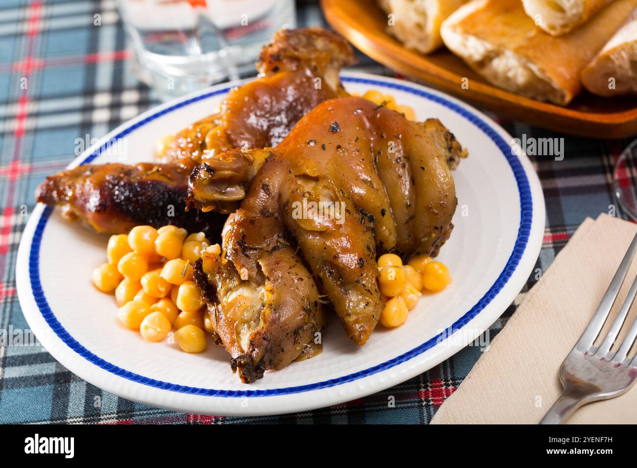 Fried pig legs with chickpeas Stock Photo - Alamy