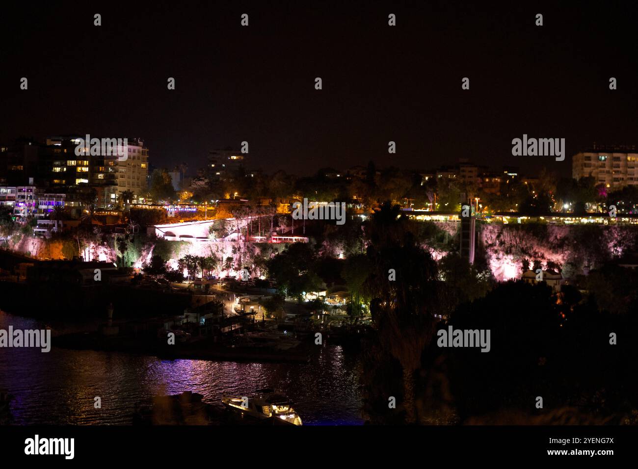 Illuminated Cliffside and City Lights Reflecting on the Waterfront at ...