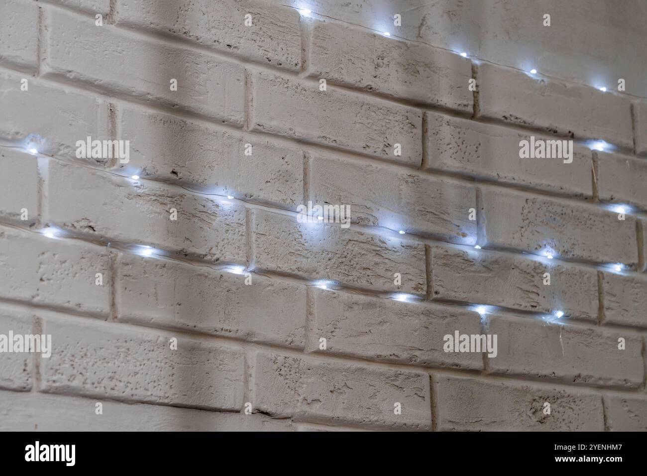 Illuminated White Brick Wall with Soft Blue LED Strips Stock Photo - Alamy