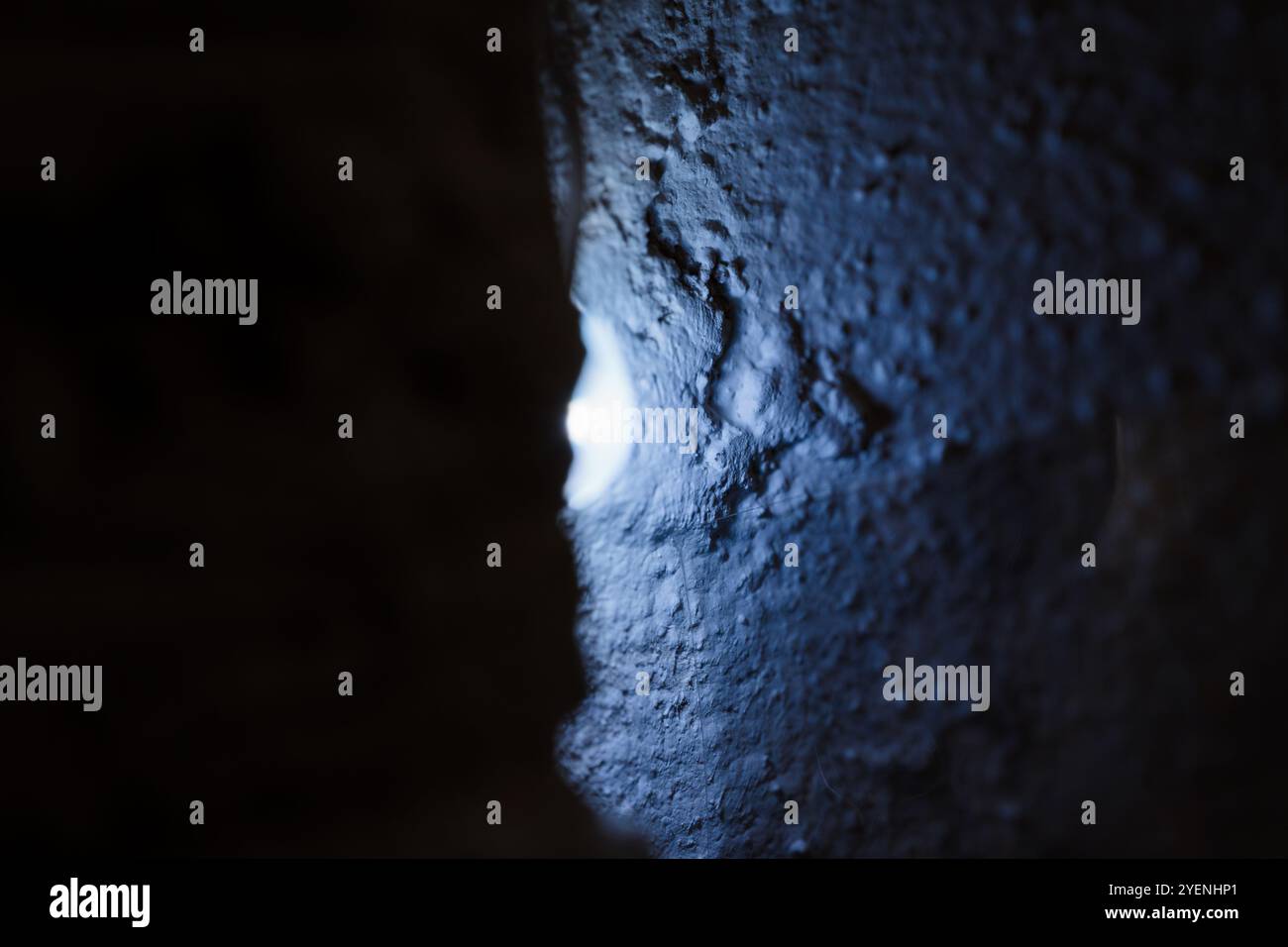 Mysterious Light Seeping Through a Narrow Crevice in a Darkened Wall ...
