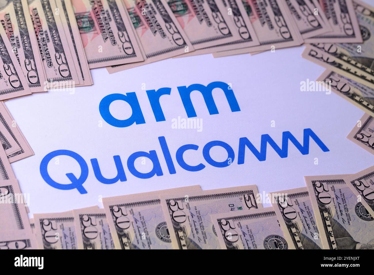 Arm and Qualcomm logos surrounded by US currency notes, reflecting ...