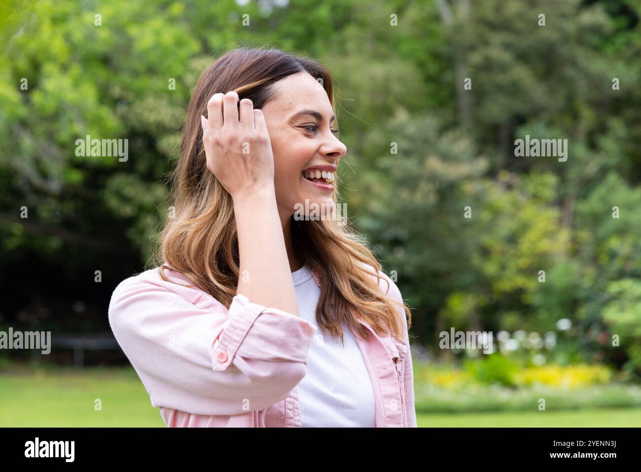 Smiling woman enjoying nature in park, feeling joyful and relaxed ...