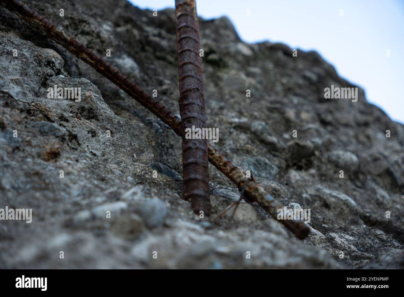 Rebar sticking out of a broken concrete wall Stock Photo - Alamy