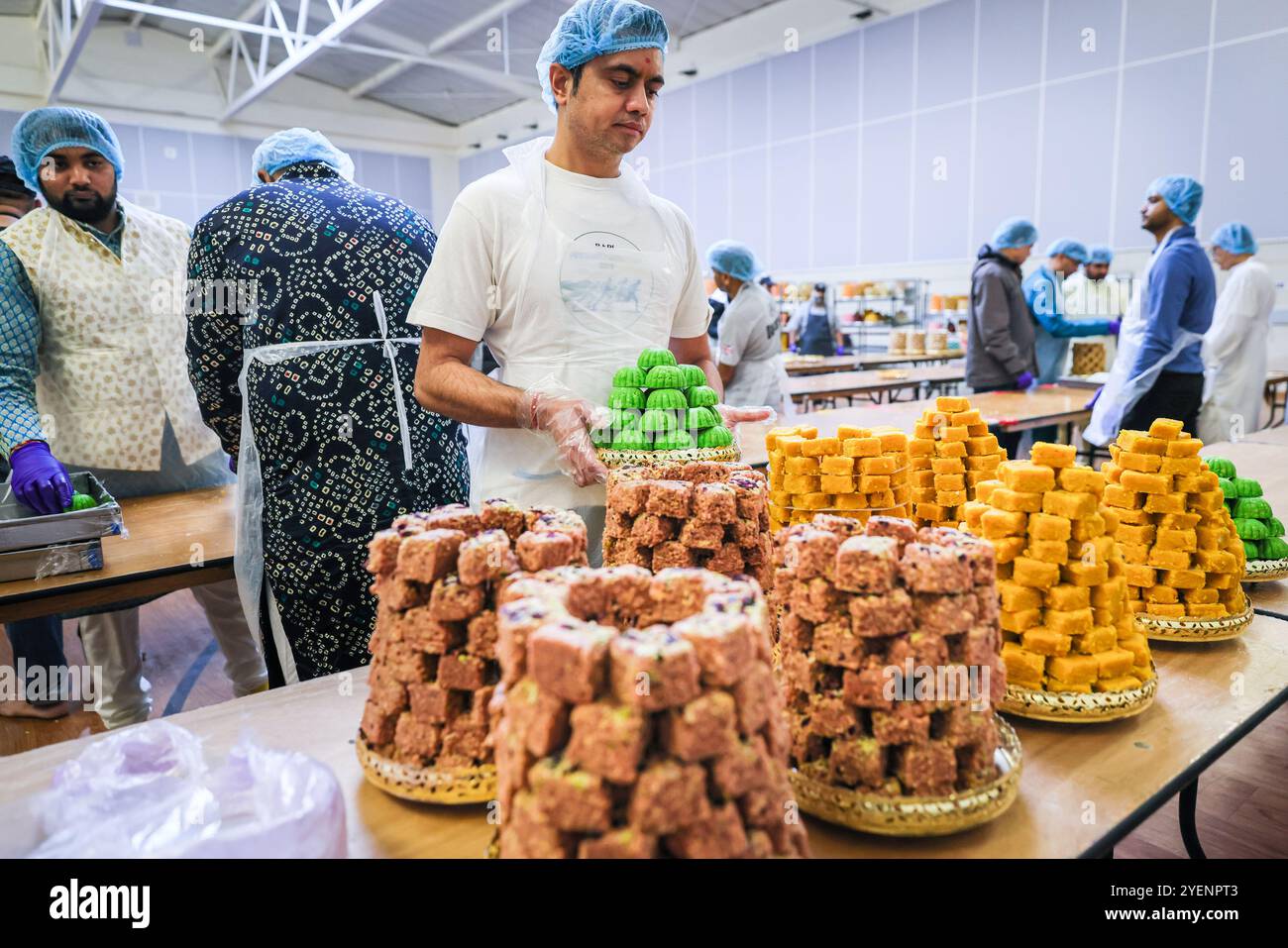 London, UK. 31st Oct, 2024. Volunteers skillfully prepare sweets for ...