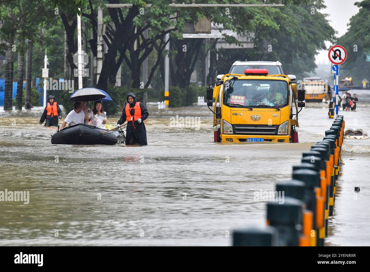 Rescue personnel use rubber boat to evacuate people from dangerous ...