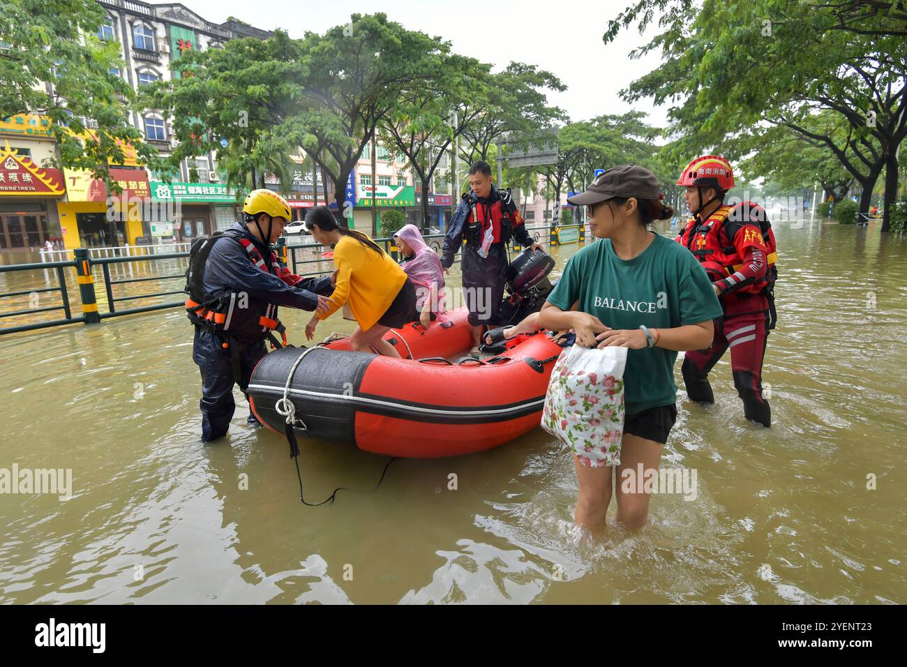 Rescue personnel use rubber boat to evacuate people from dangerous ...