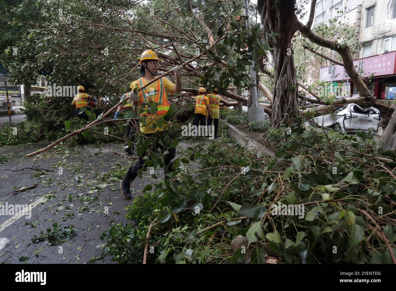 A sanitation worker of Taipei city government clears debris in the ...