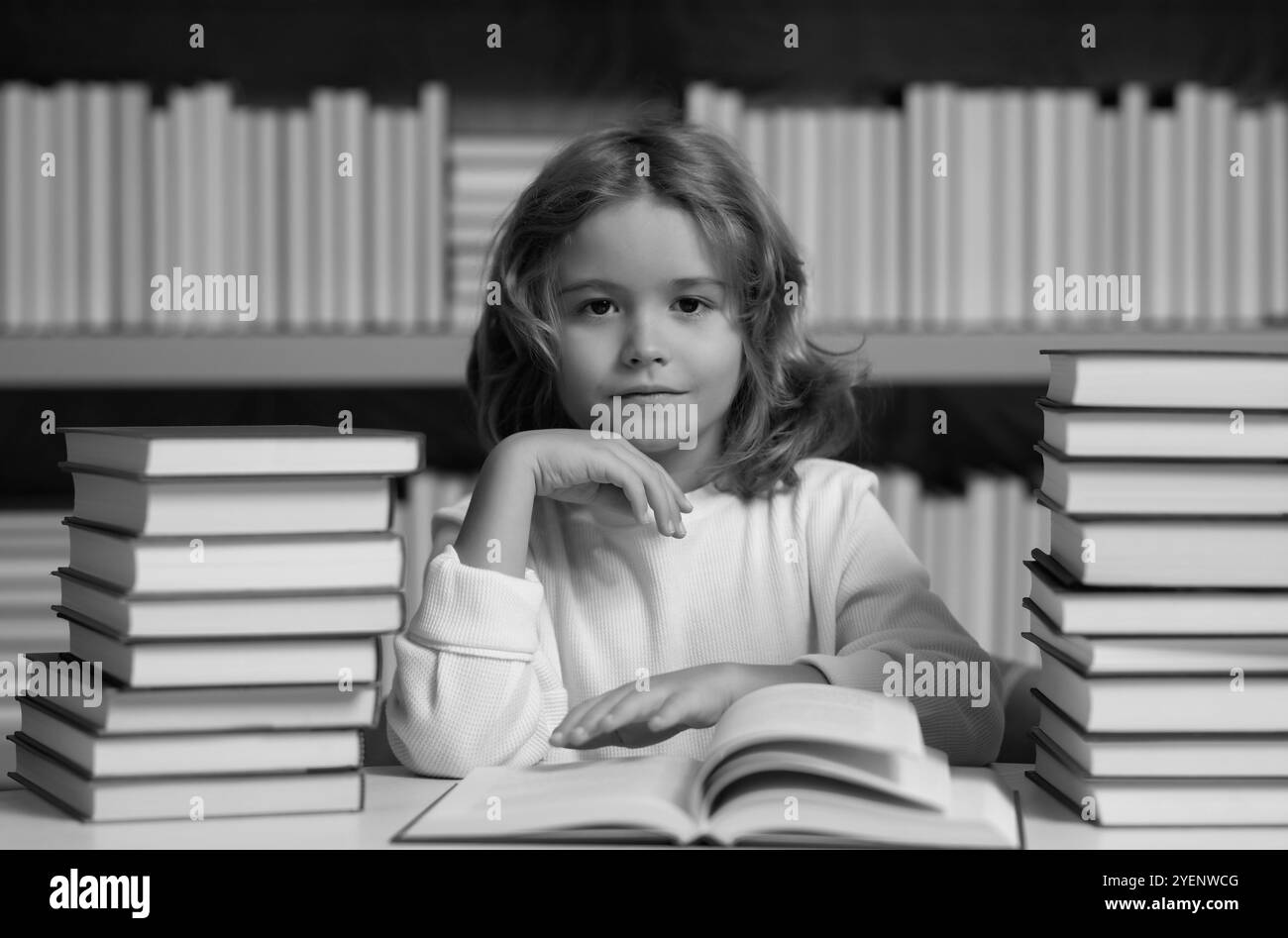 Back to school. Child reading book in a book store or school library ...