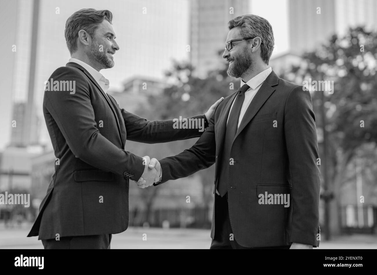 American businessman shaking hands with partner. Two businessmen ...