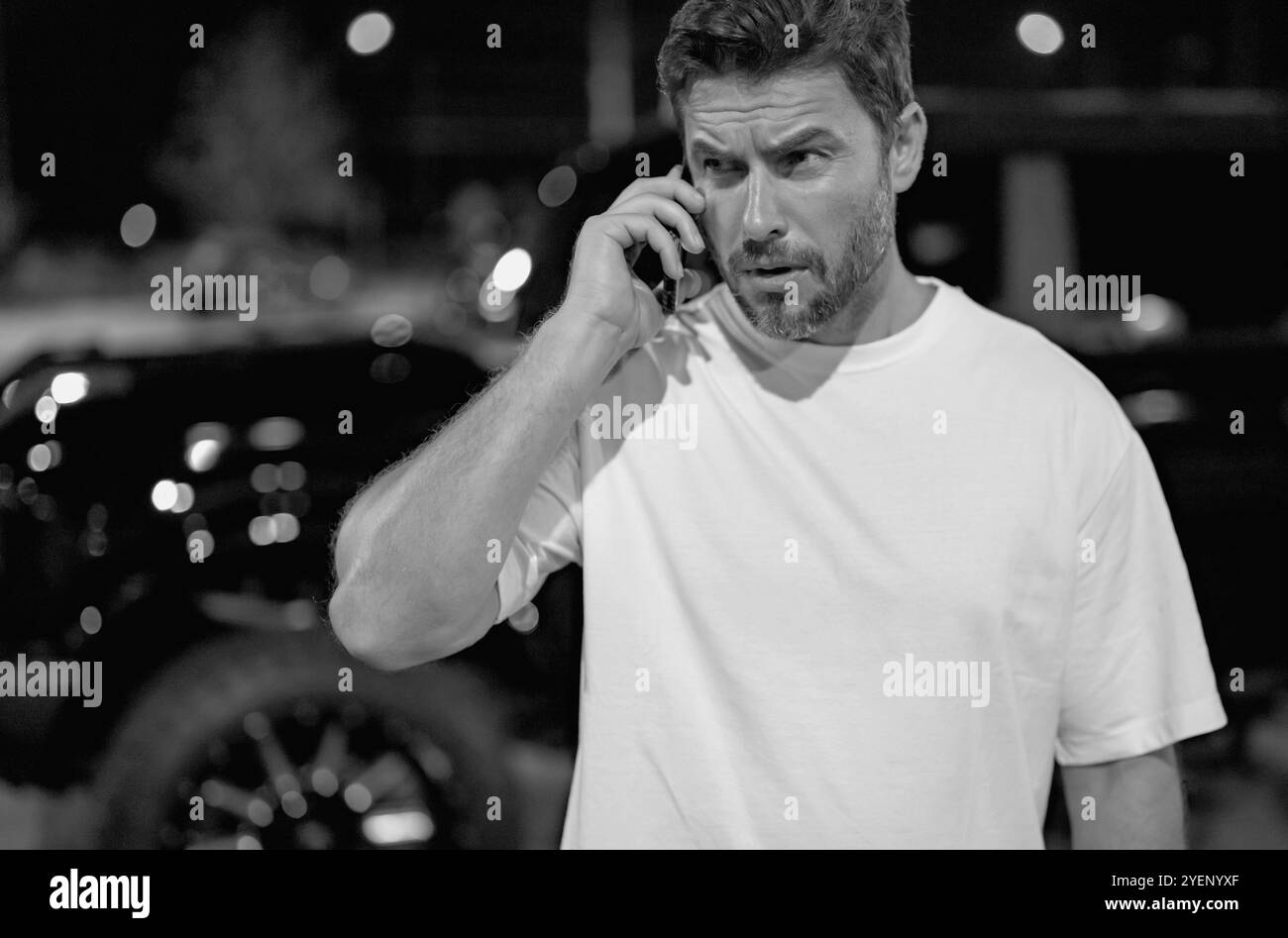 Gangster call phone. Angry man chatting on phone near car on night ...