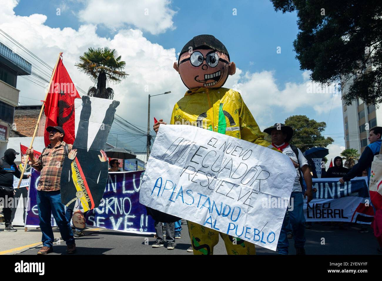 Quito, Ecuador. 31st Oct, 2024. A protester in a costume holds a ...