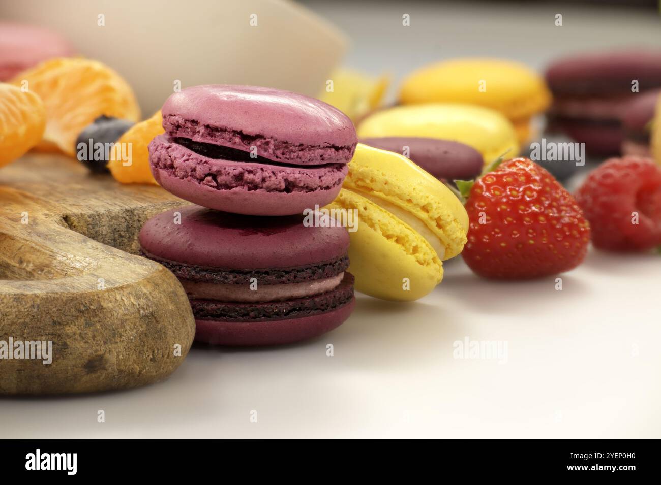Table filled with macaroons and fruits visual appeal of the food joy of ...