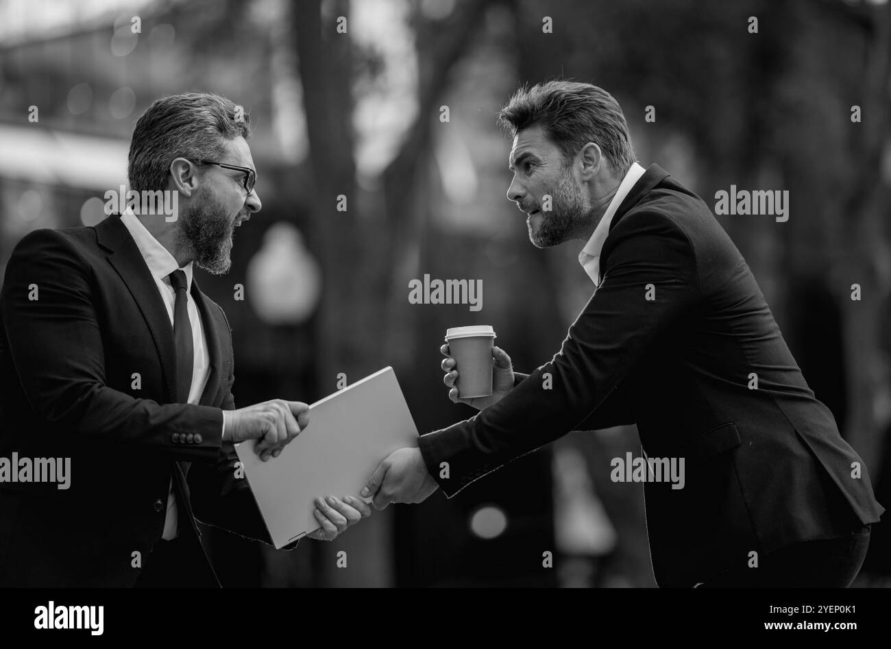 Businessmen fighting outdoor. Business conflict between business men in ...