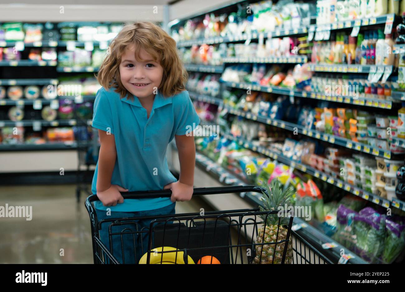 Child with shopping cart at grocery store or supermarket. Purchases ...