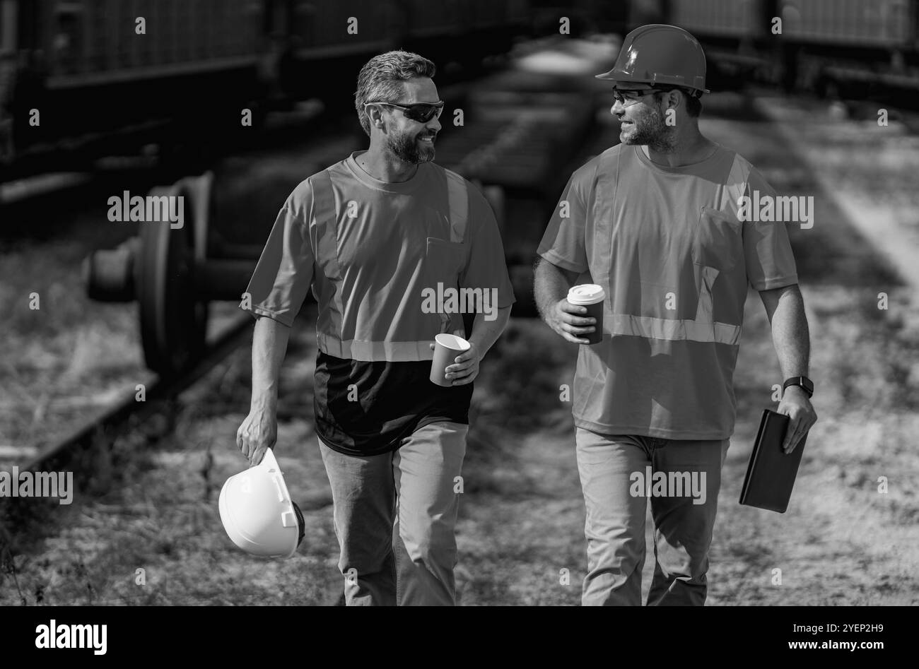 Builders on the job. Two builders in a hard hat at construction site ...