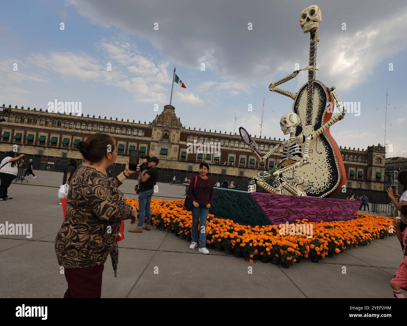 A person taking photos of the Mega Ofrenda featuring monumental ...