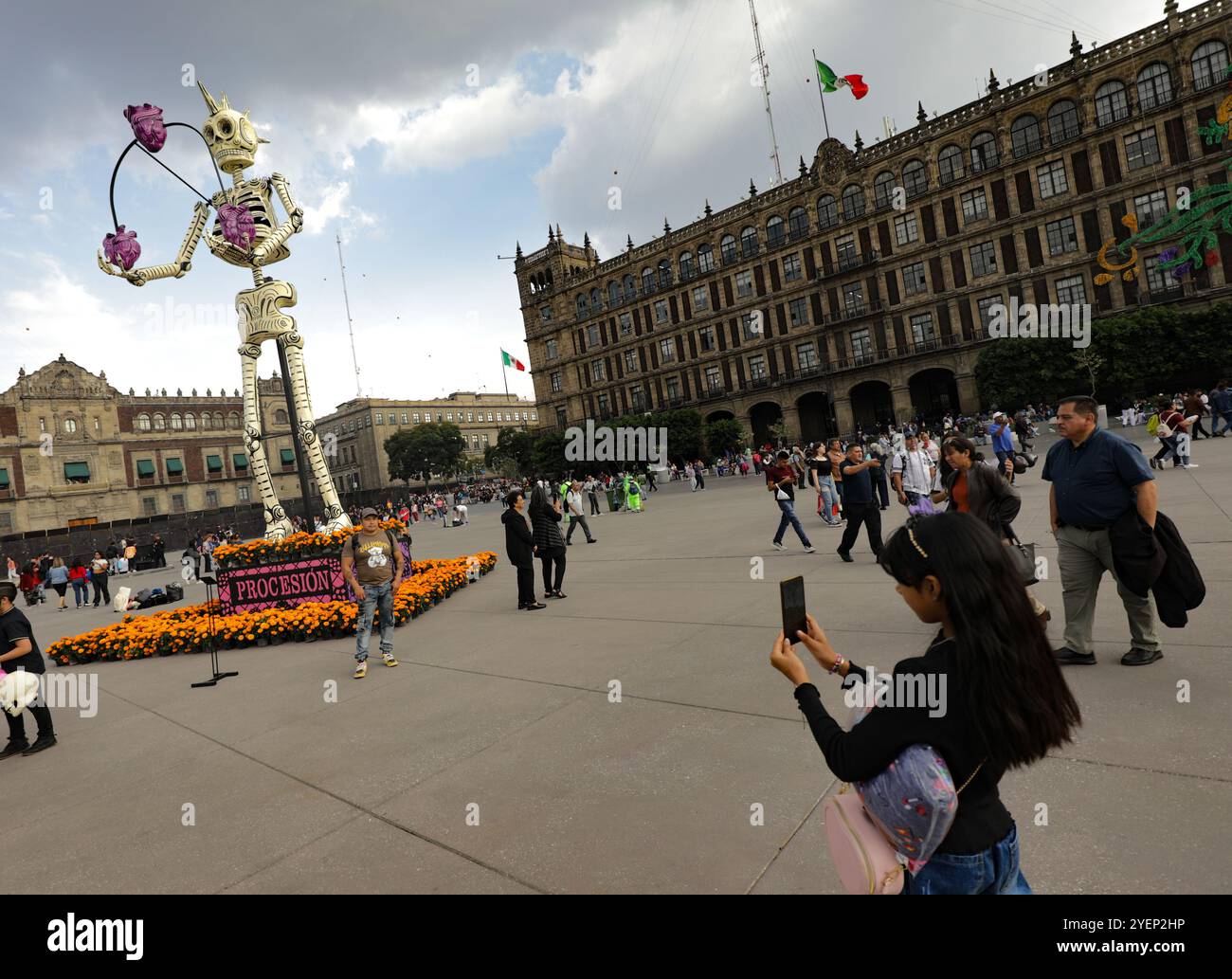 A person taking photos of the Mega Ofrenda featuring monumental ...