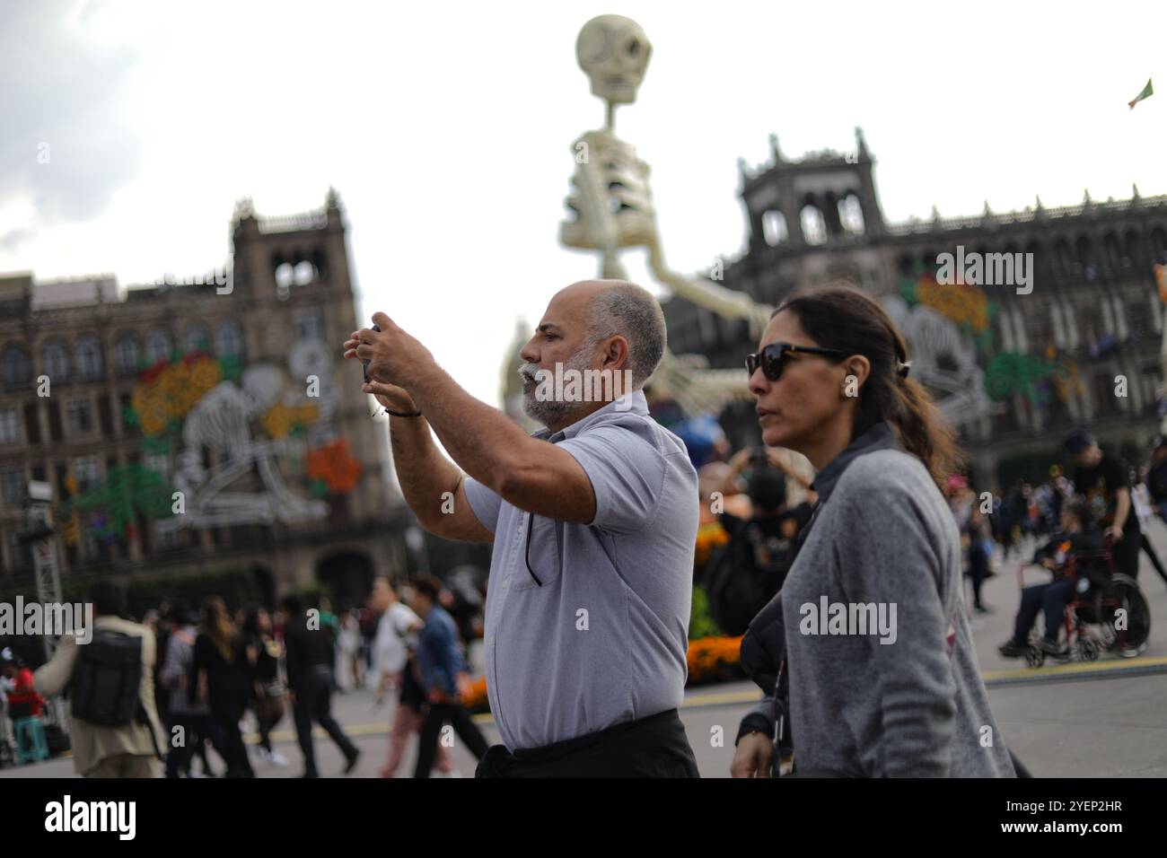 A person taking photos of the Mega Ofrenda featuring monumental ...