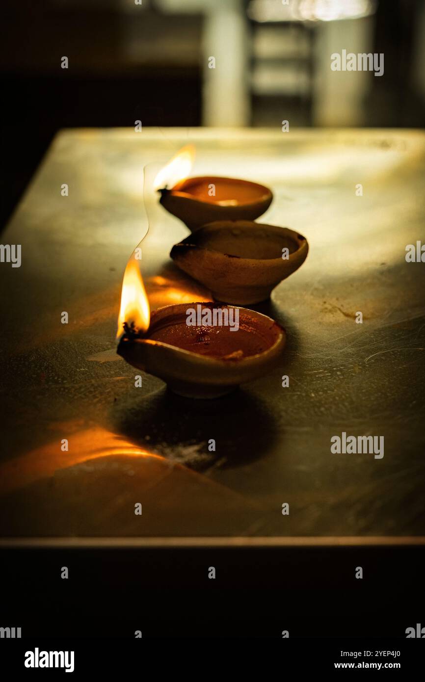 Diwali burning lamps close up in the temple Stock Photo - Alamy