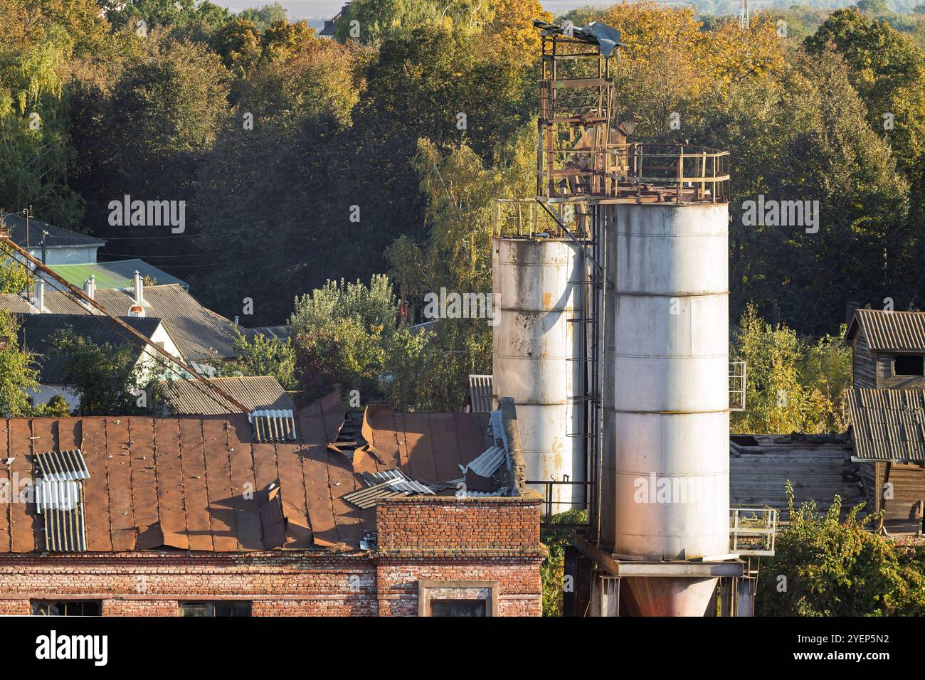 Old abandoned industrial building with rusty roof and decayed structure ...