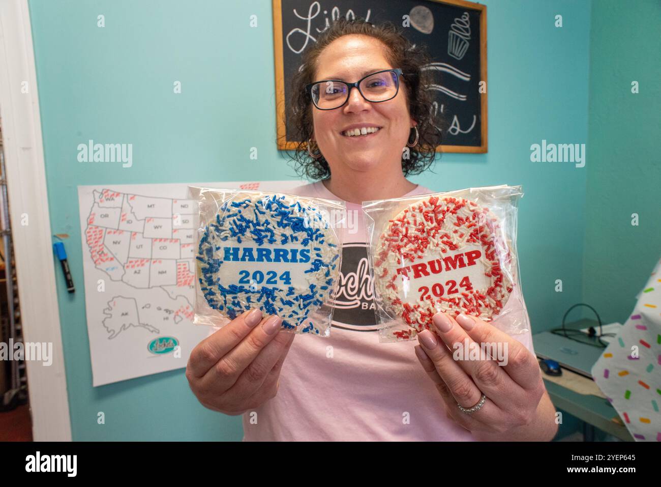 Kathleen Romano Lochel holds Harris and Trump cookies while the bakery ...