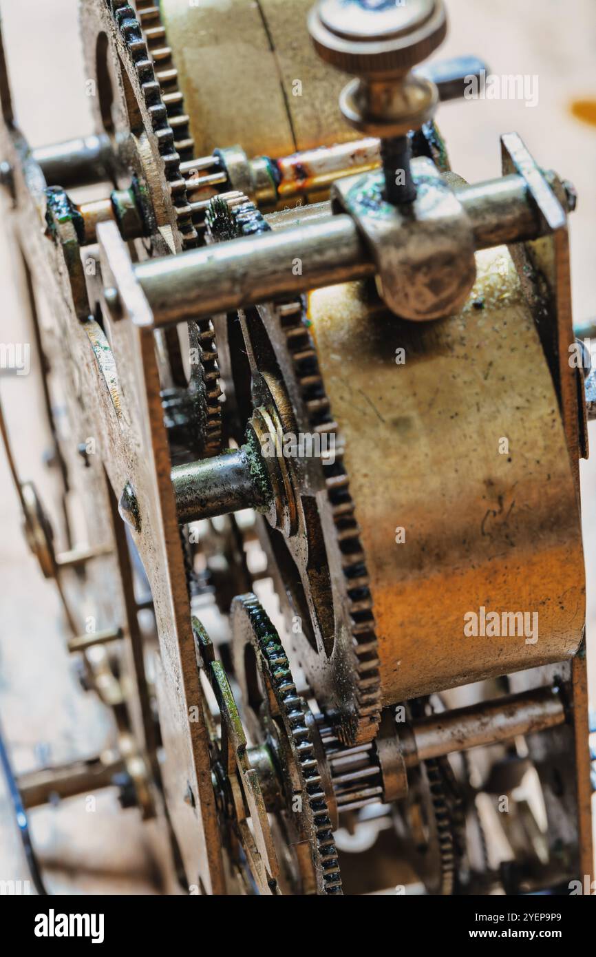 Close-up of old watch mechanism shows interlocking gears with wear and ...