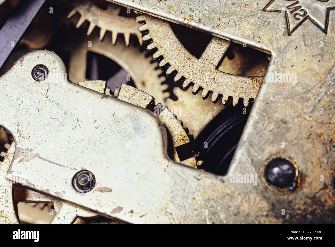 Complex array of gears in antique watch mechanism, showing oxidation ...