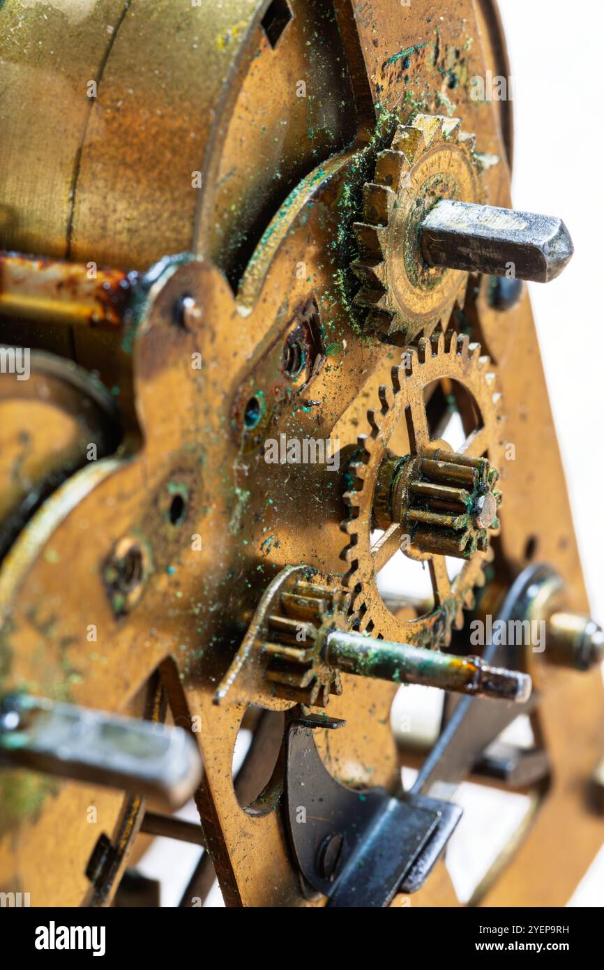 An aged watch mechanism displays worn gears and old lubricant traces ...