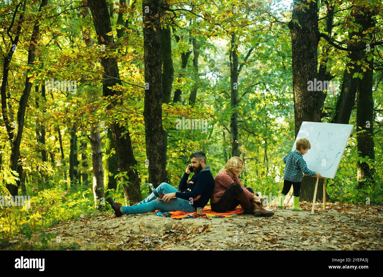 Alternative workday. Handsome son drawing family giving joyful moments ...