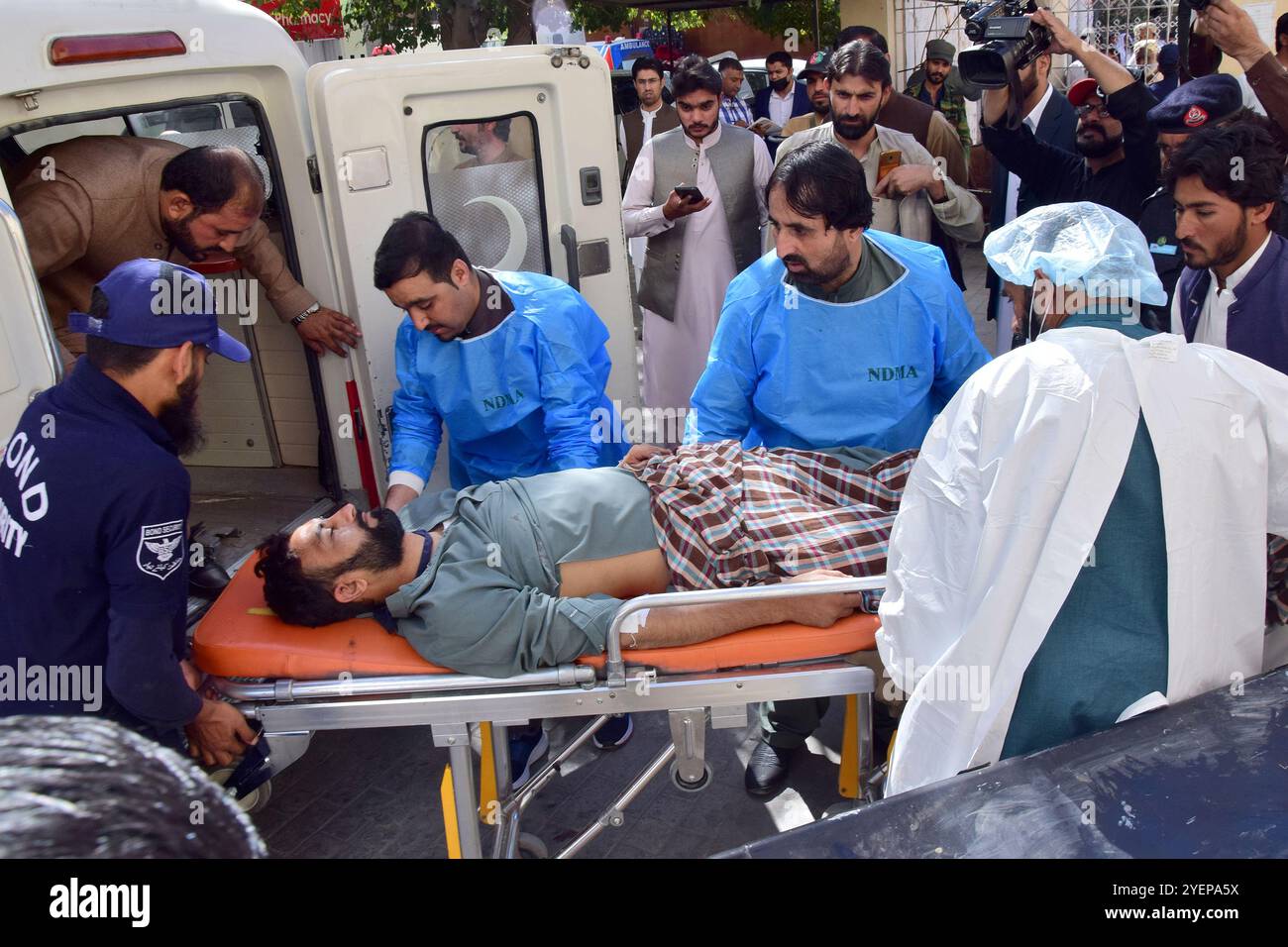 Paramedics and volunteers transport an injured victim of a bomb ...