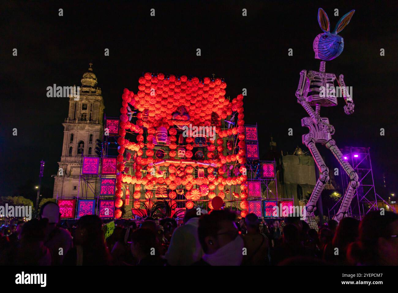 A vibrant Day of the Dead altar with illuminated decorations and ...