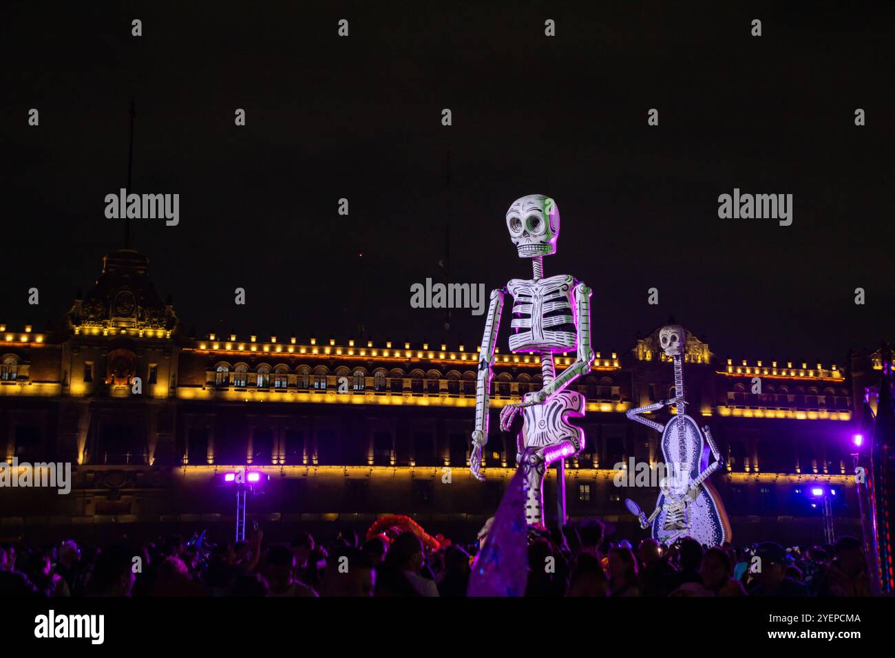 Giant skeleton figures stand in Mexico City's Zócalo during a nighttime ...