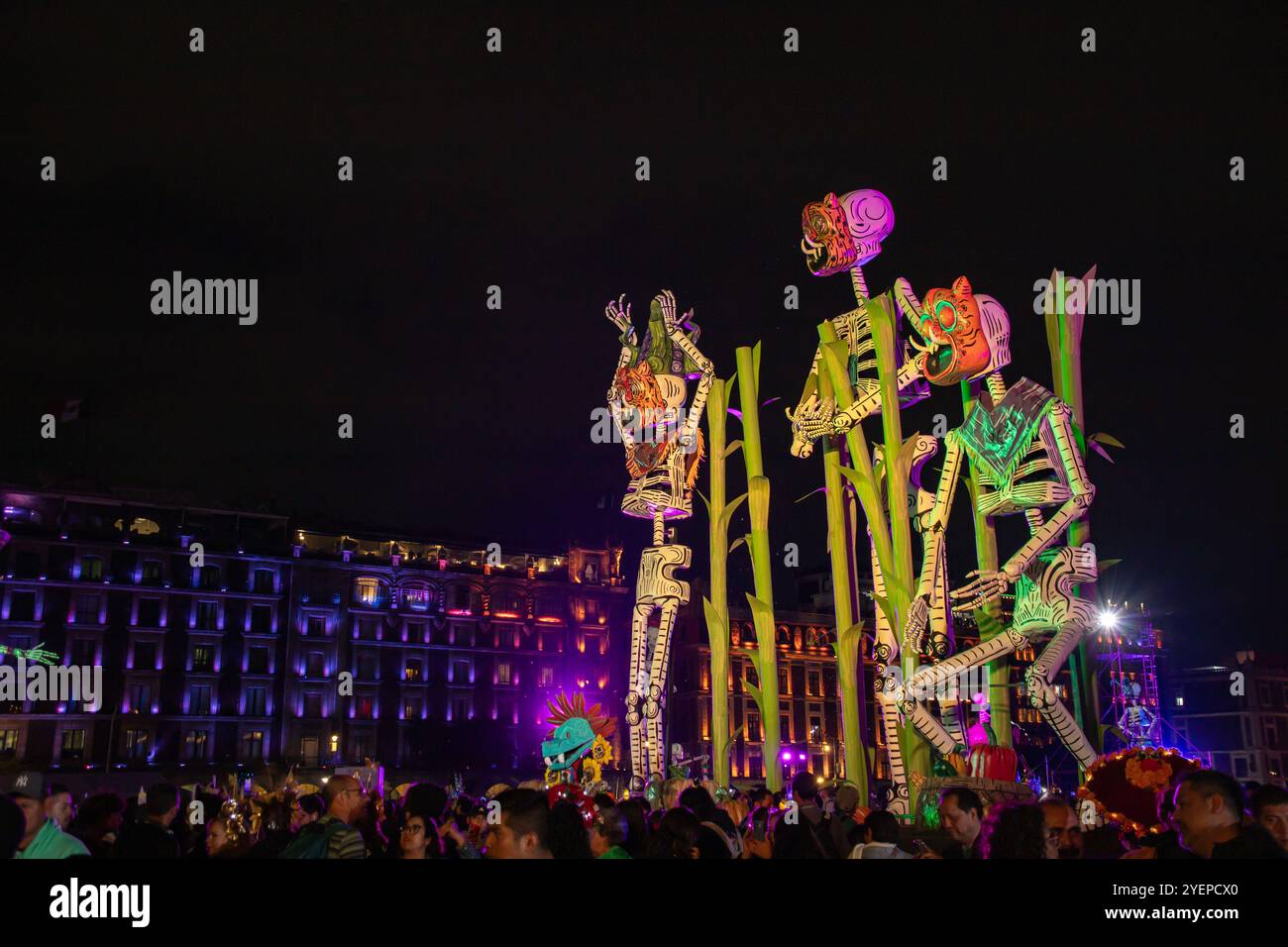 Large illuminated skeleton sculptures stand among vibrant decorations ...