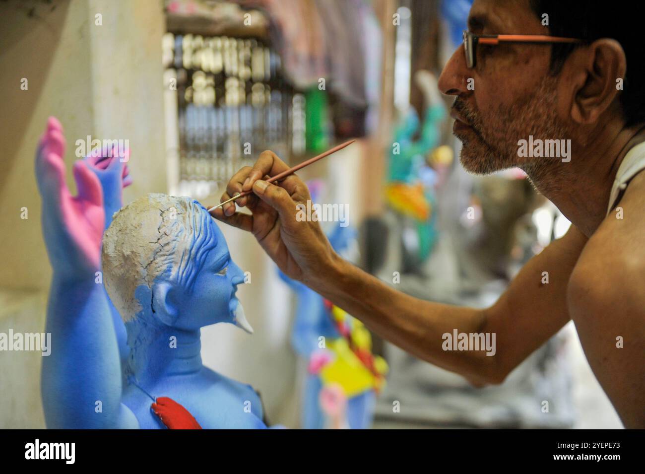 An idol artist is busy coloring the Goddess Kali sculpture ahead of the ...